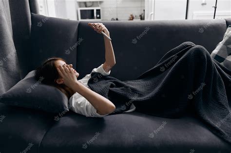 Premium Photo Woman Lying On The Couch With A Phone In Her Hands Sensor New Technology Pillow
