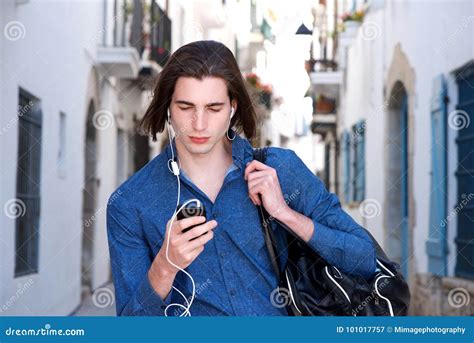 Close Up Man Walking With Headphones And Cellphone On Street Stock