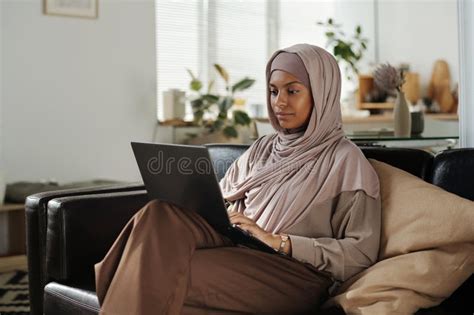Young Pretty African American Woman In Hijab Typing On Laptop Keyboard