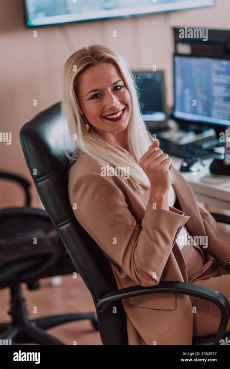 A Businesswoman Sitting In A Programmer S Office Surrounded By