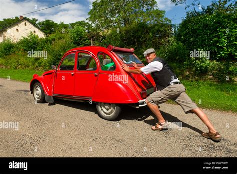 Typical French Man Is Pushing His Car After A Breakdown Stock Photo Alamy