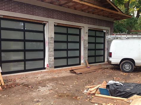 Modern Aluminum Garage Doors With Frosted Door Lites Installed In A New