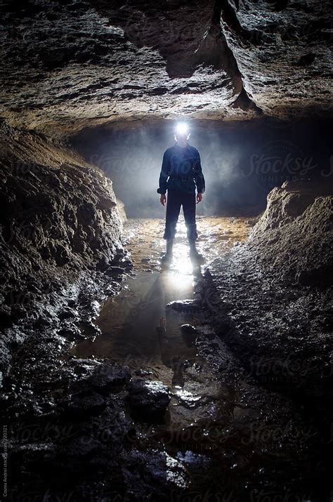 Man Exploring Cave By Stocksy Contributor Cosma Andrei Stocksy