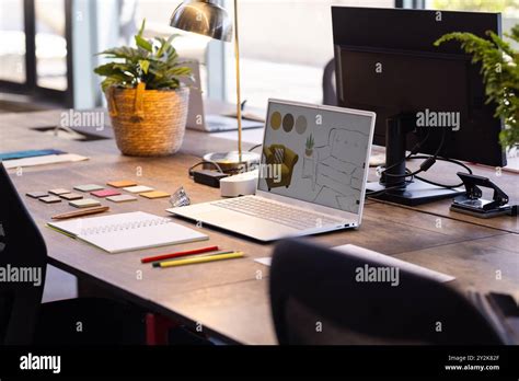 At Office Designing Interior Layout Laptop With Sketches On Desk Surrounded By Color Swatches