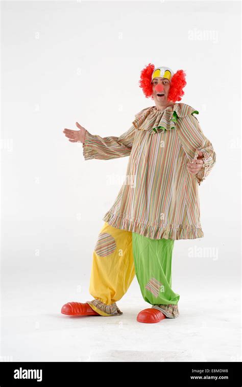 Man Dressed In Fancy Dress Comedy Costume In A Circus Clown Outfit With
