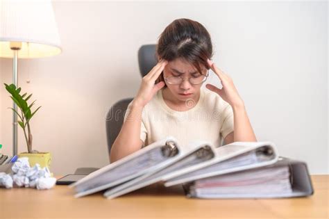 Female Businesswoman Having Headache And Migraine At Office Asian