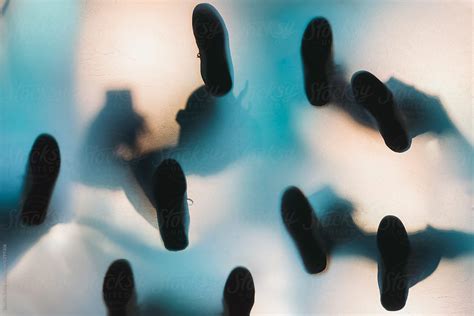 Feet Walking On An Opaque Glass Floor With Lights By Stocksy
