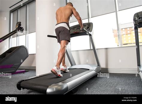 Handsome Man Running On The Treadmill In Gym Stock Photo Alamy