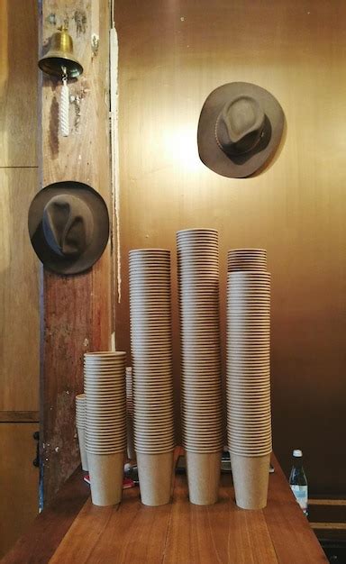 Premium Photo Stacked Disposable Glasses On Table