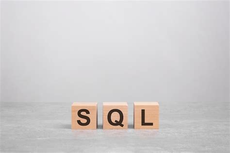 Premium Photo Business Concept Wooden Cube On A Concrete Surface With Text Sql