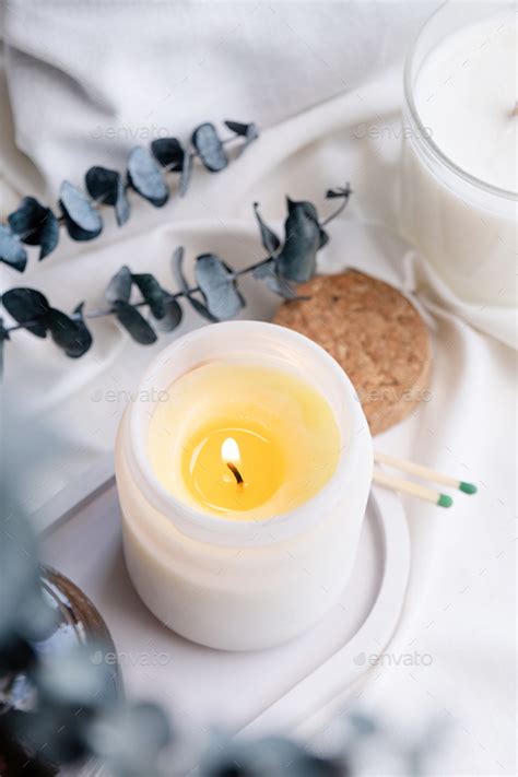 Soy Wax Aroma Candle In White Jar On Bed With Eucalyptus Leaves Candle