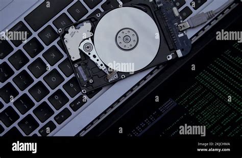 hard drive lies on the laptop keyboard flashes and disk spins stock