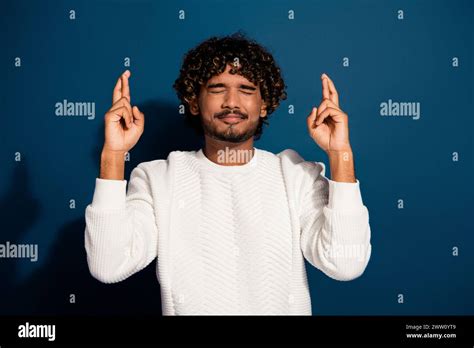 Portrait Photo Of Young Funny Curly Hair Indian Guy Crossed Fingers
