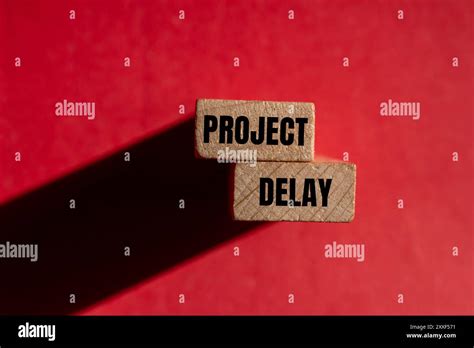 Project Delay Message Written On Wooden Blocks With Red Background