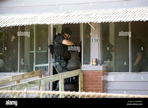 Police Officers From Tactical Narcotics Unit Carrying Out High Risk