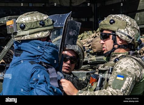 Ukrainian Soldiers Help Dress Eod Tech Into A Bomb Disposal Suit