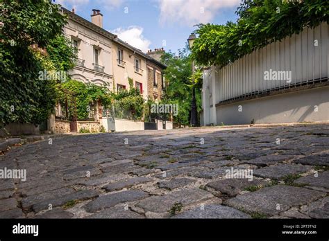 The paved streets and pretty low houses of La Campagne ä Paris the