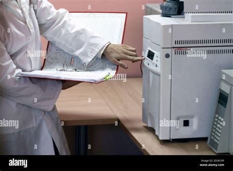 Engineer Ecologist Presses A Button On The Machine For Environmental Analysis Test Samples Of