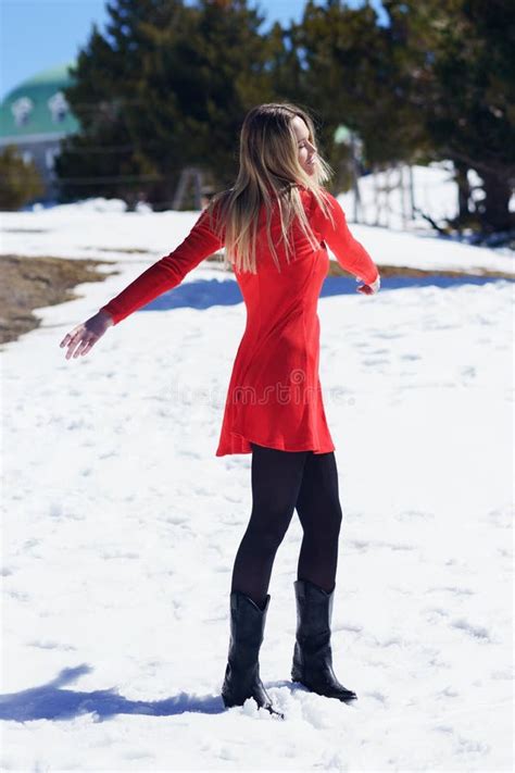 Woman Wearing A Red Dress And Black Stockings Opening Her Arms In