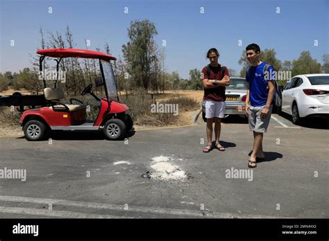 Israelis Stand Next To A Damage Done By A Missile Launched From Gaza