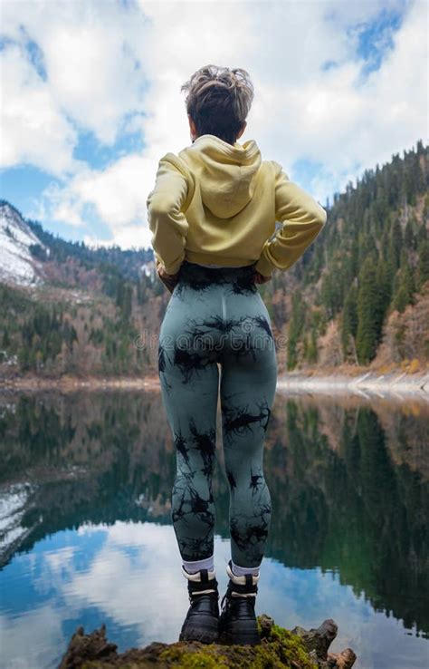 A Tourist Girl With A Figure Admires The Beauty Of Nature Against The