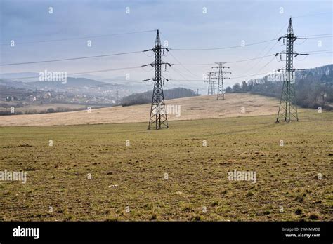 Old Power Grid Transmission Towers On Agricultural Land And Pastures In