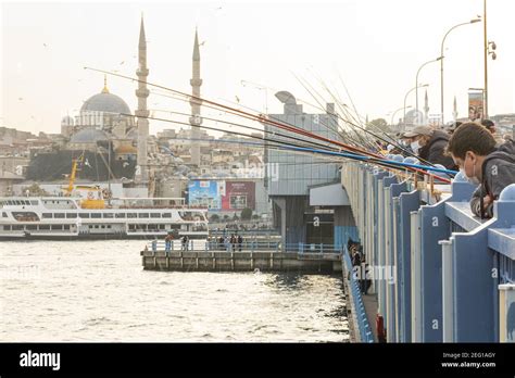 Galata Bridge Mosque And Fisherman Fishing On The Bridge In Bosphorus
