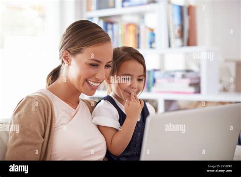 Showing Her Daughter How To Browse Safely A Mother Using A Laptop With