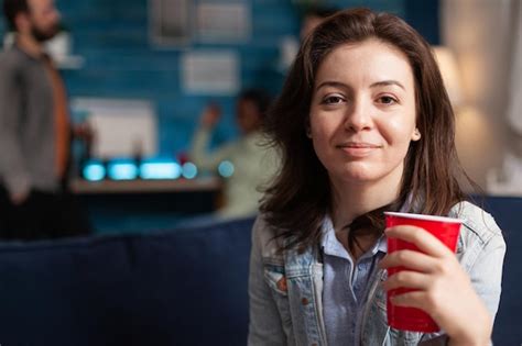 Premium Photo Portrait Of Smiling Young Woman Holding Drink