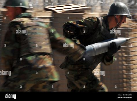 An Afghan National Army Artilleryman Dashes Toward The D 30 Howitzer