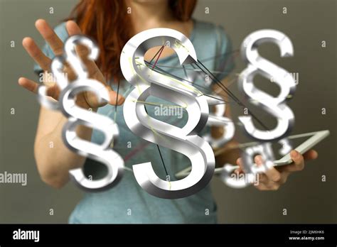 A Female With A Tablet Pressing On A Floating Hologram Of Interconnected Law Symbols Stock Photo