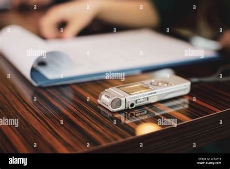 Shallow Depth Of Field Selective Focus Image With An Audio Recorder Of A Woman Journalist