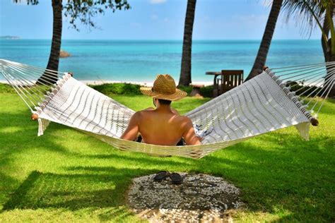 Premium Photo Rear View Of Shirtless Man Sitting On Shore