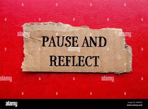 Pause And Reflect Words Written On Ripped Cardboard Paper Piece With Red Background Conceptual