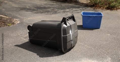 Overflowing Trash Can Next To Recycling Bins Symbolizes The Importance