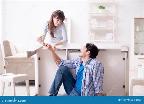 The Husband Repairing Broken Table At Home Stock Photo Image Of Chair Repair
