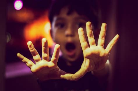 Premium Photo Shocked Boy Gesturing Stop Sign In Illuminated Room