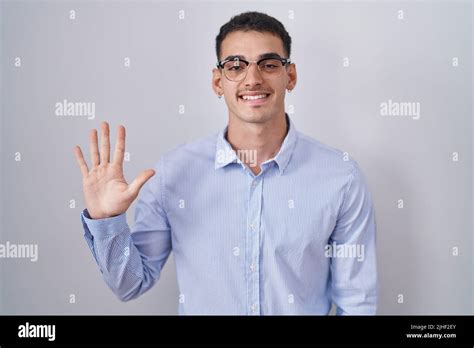 Handsome Hispanic Man Wearing Business Clothes And Glasses Showing And