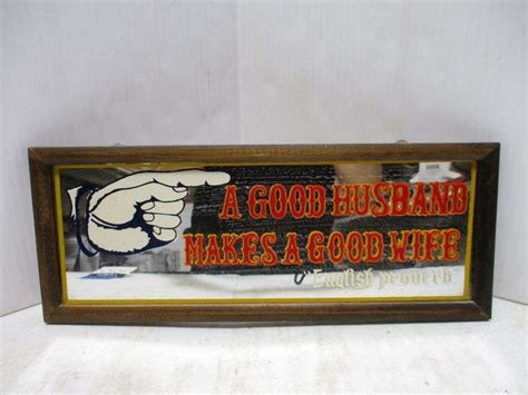 Old Mirrored Sign Reads A Good Husband Makes A Good Wife” English