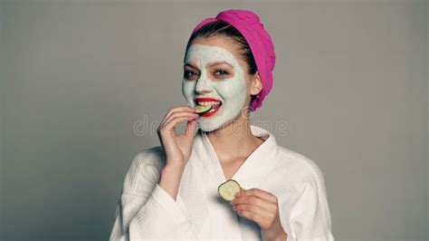 A Girl With A Mask On Her Face And A Towel On Her Head Closes Her Eyes