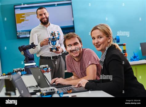 A Group Of Colleagues Working Together In A Robotics Laboratory