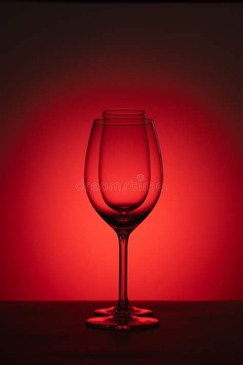 Two Empty Glasses On Red Background Luxury Drink Glasses In Red Lights