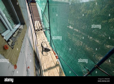 Hand Drill On The Scaffolding On Altitude Concept Repairing The Wall