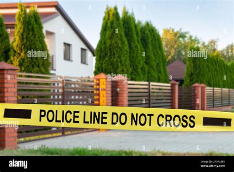 Yellow Crime Scene Tape Blocking Way To House Outdoors Stock Photo Alamy