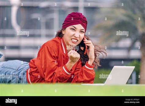 Frustrated And Angry Indian Woman Talk By Phone And Working Outdoor On