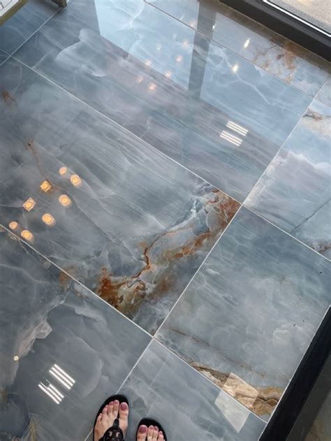 A Person Standing In Front Of A Tiled Floor