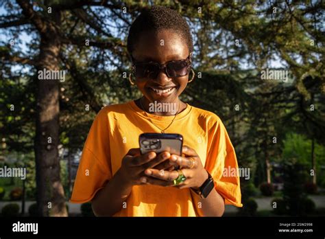 Cheerful Smiling Black African Girl Texting Messaging Online Typing