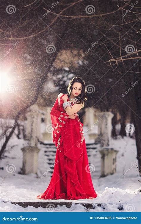 Beautiful Young Girl Dancing Belly Dance In Red Dress In Winter In A