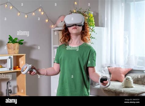 Redhead Teen Girl At Home In Living Room Put On Vr Helmet To Enjoy
