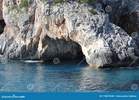 Girl Swimming Near The Cave In Cala Luna Beach Is One Of The Most